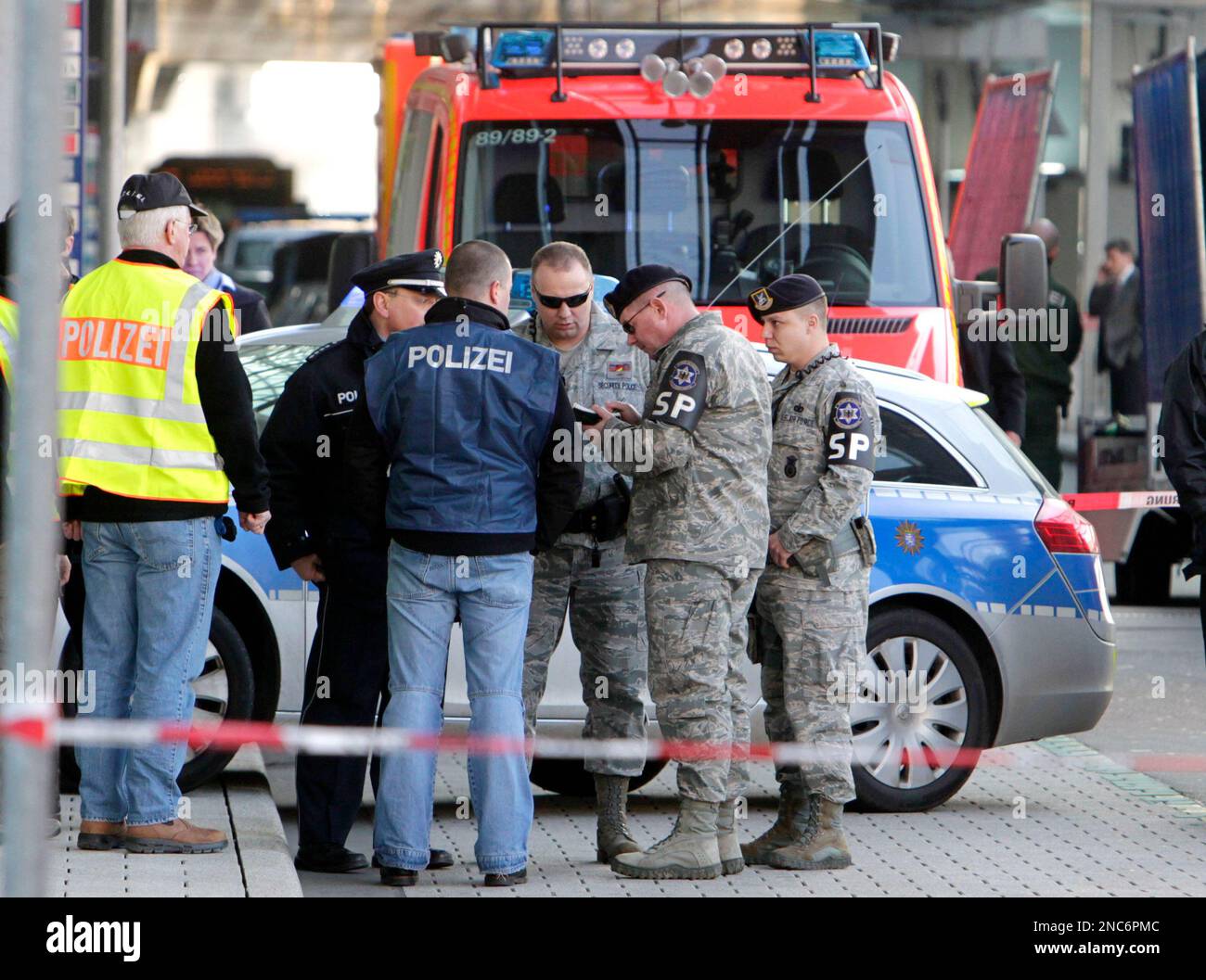 German police and US soldies talk after a gunman fired shots at U.S ...