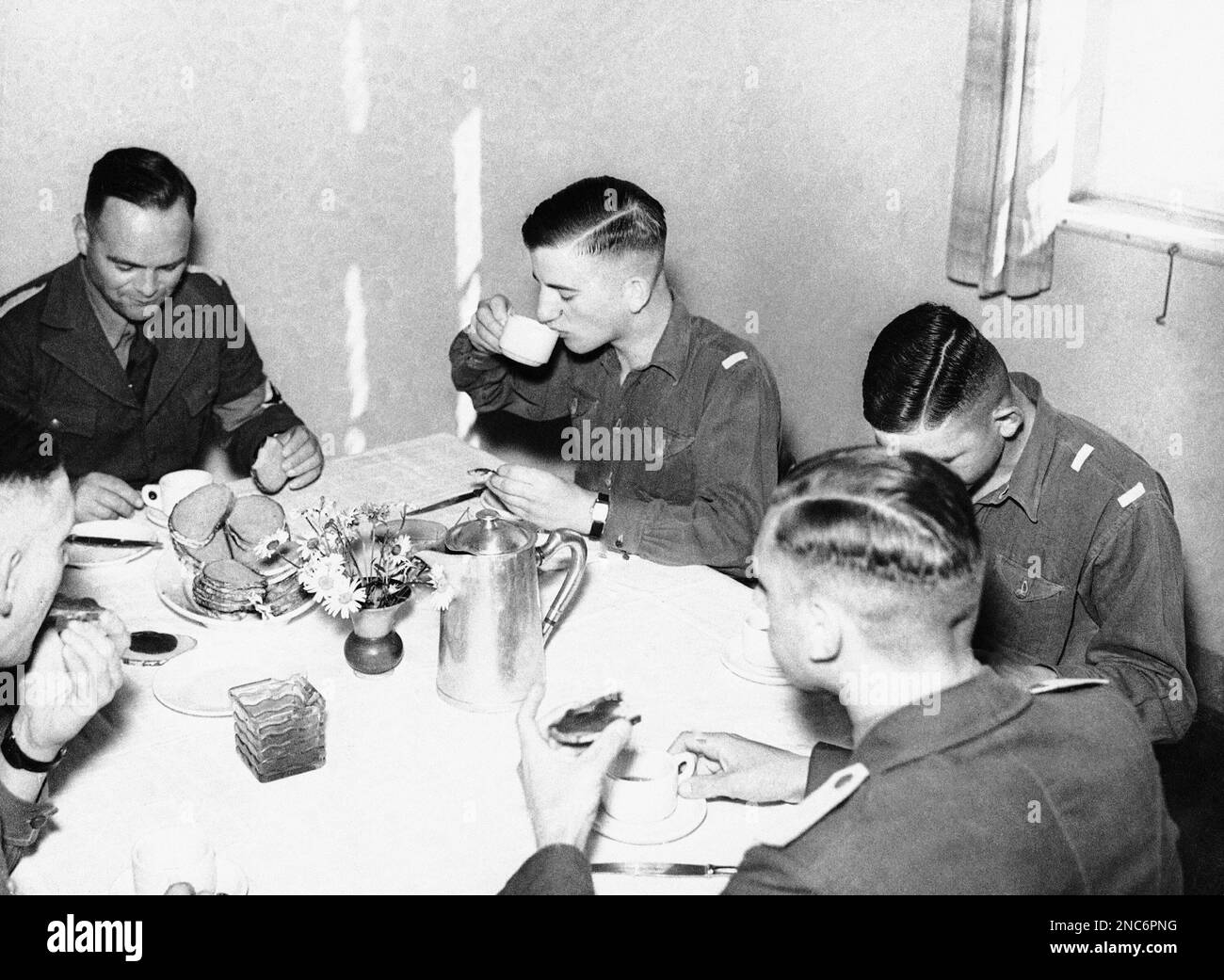 Teacher, far left, and students, Hitler Youth boys, take breakfast ...
