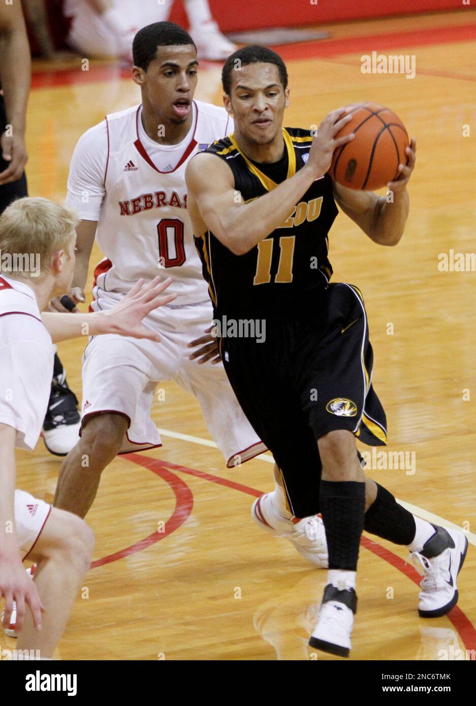 Missouri's Michael Dixon, Jr. (11) is defended by Nebraska's Toney ...