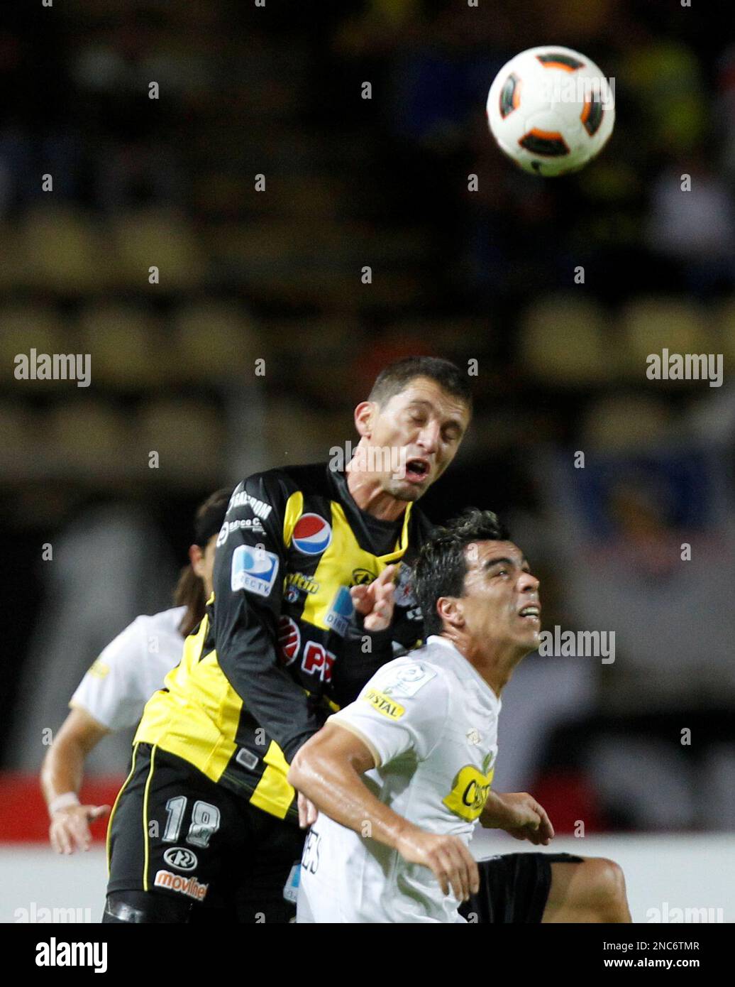 Chile's Colo Colo Esteban Paredes, right, fights for the ball with Venezuela's Deportivo Tachira ...
