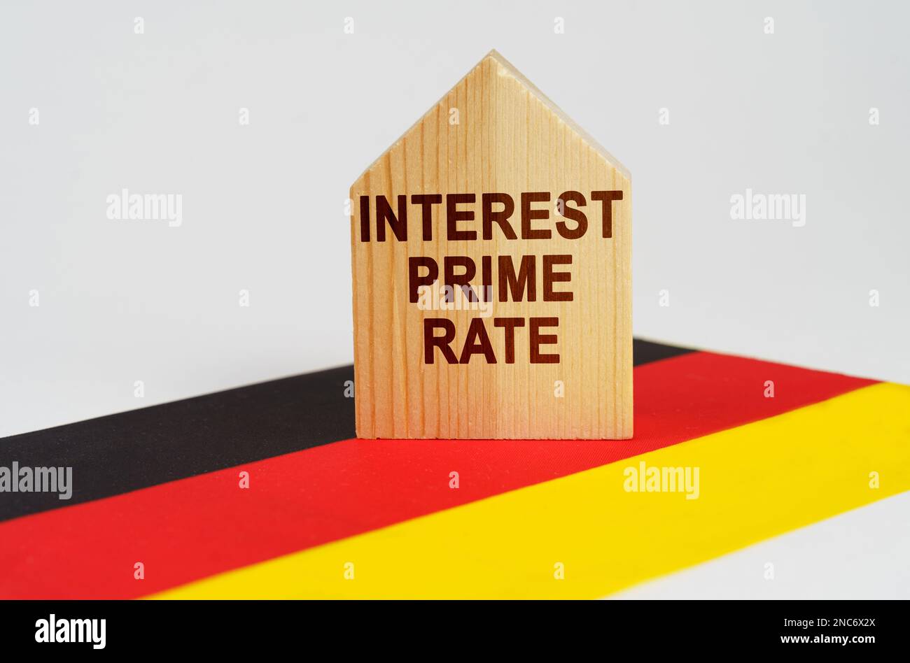 Real estate concept. On the flag of Germany there is a model of a ...