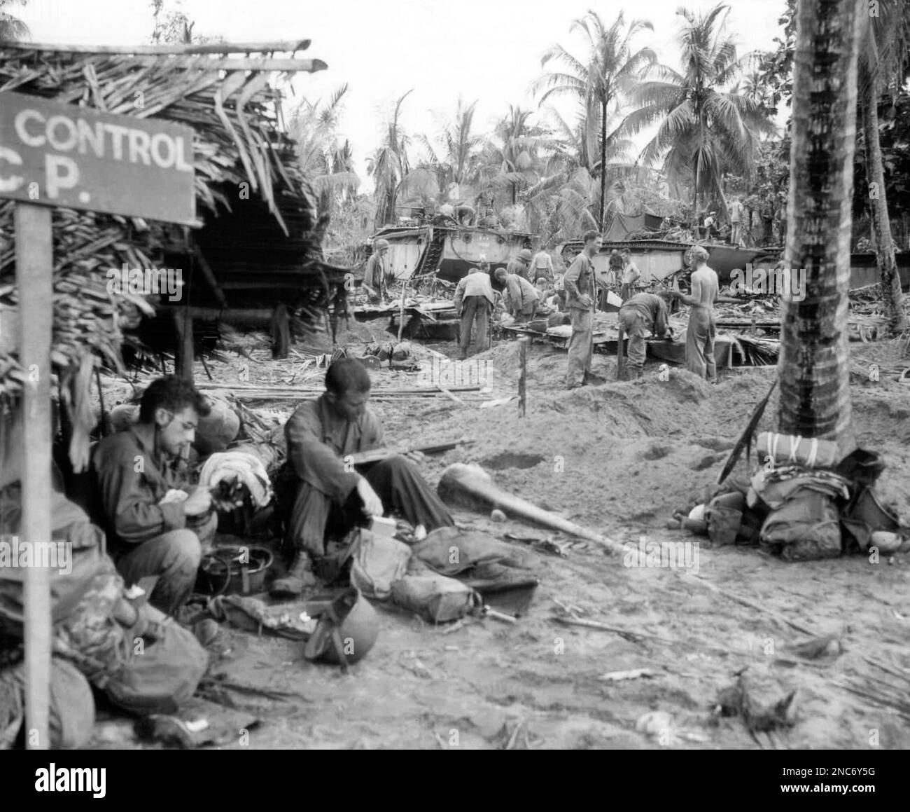 Army men clean up along the wrecked shore line at Karako, New Guinea on ...