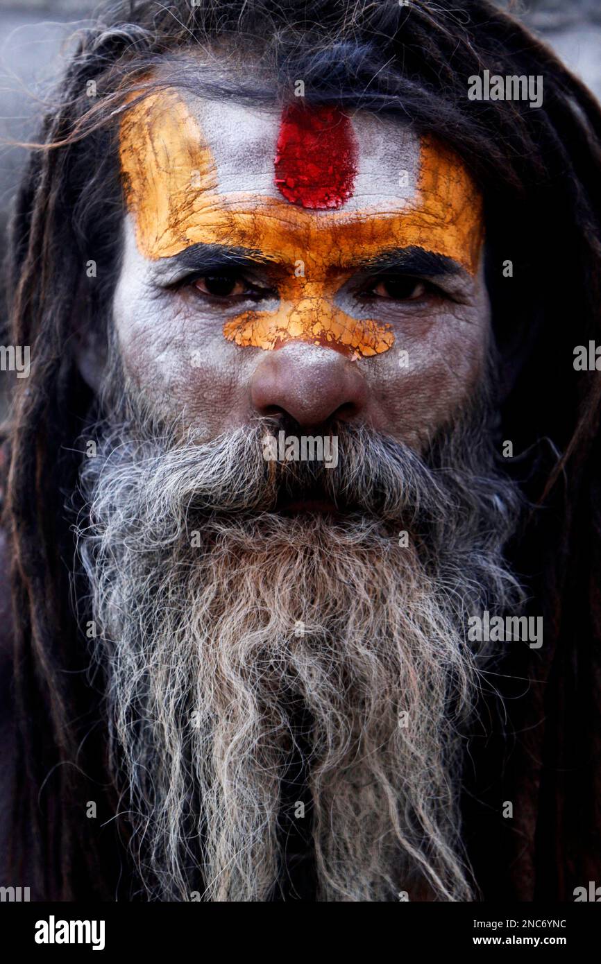 A Hindu holy man looks on at the courtyard of Pashupati temple in ...