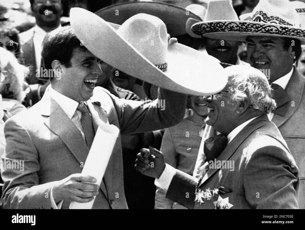Britain’s Prince Andrew smiles after he was presented with a sombrero ...