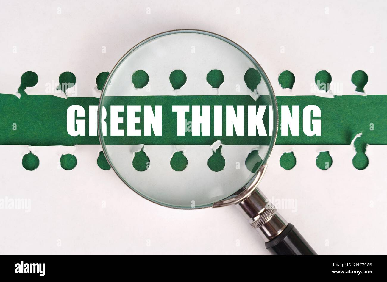 Between two sheets from a notebook on a green strip with the ...