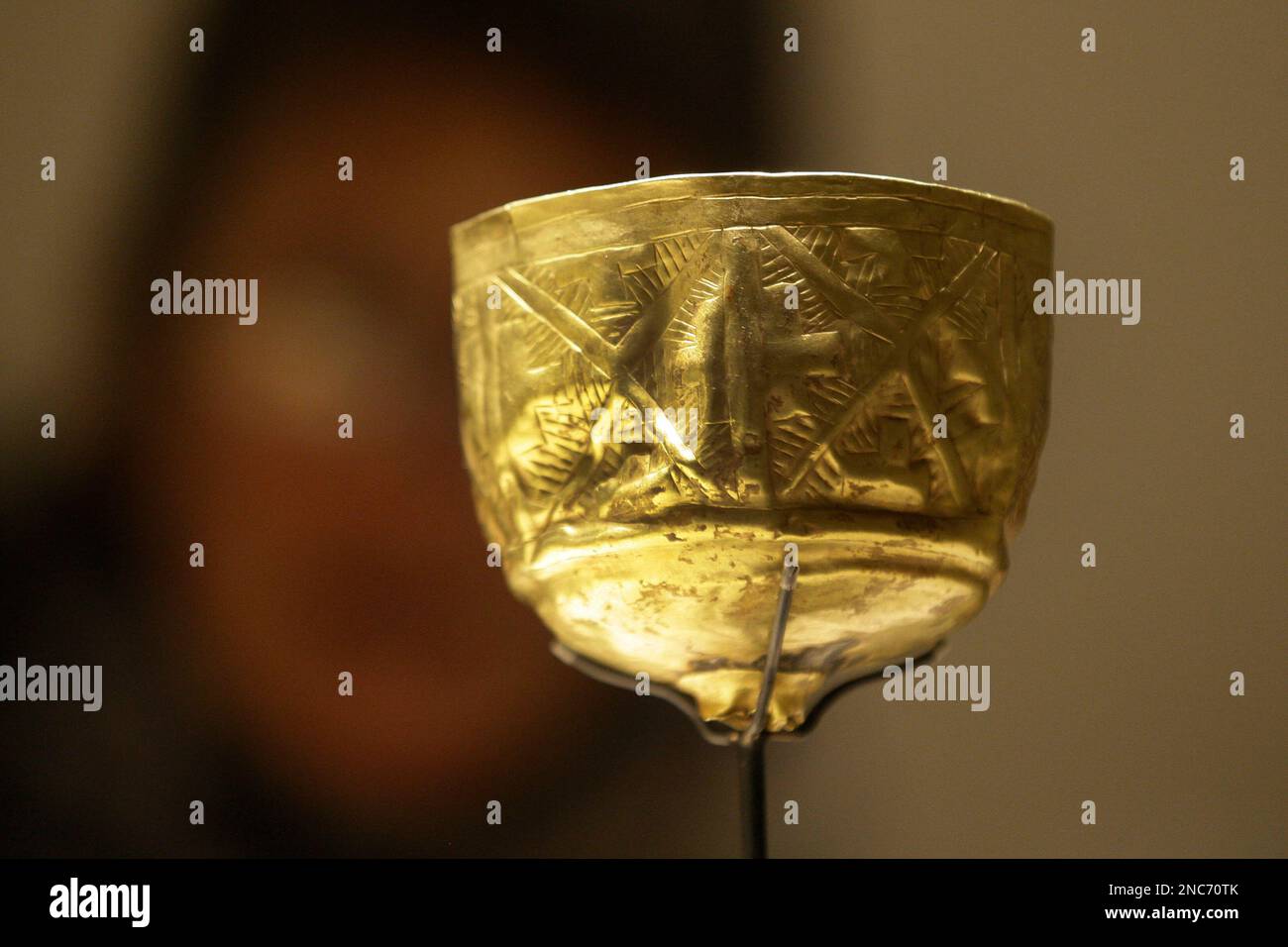 A visitor looks at a 2200-1900 BC gold goblet discovered at Tepe Fullol ...