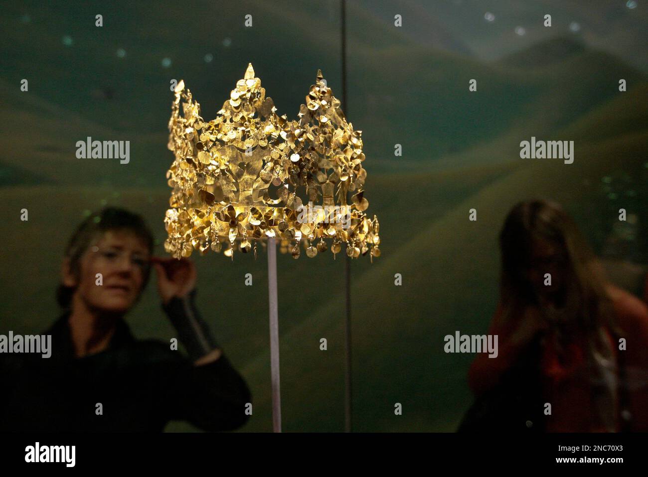A visitor looks at a 1st century AD gold crown discovered in the tomb ...
