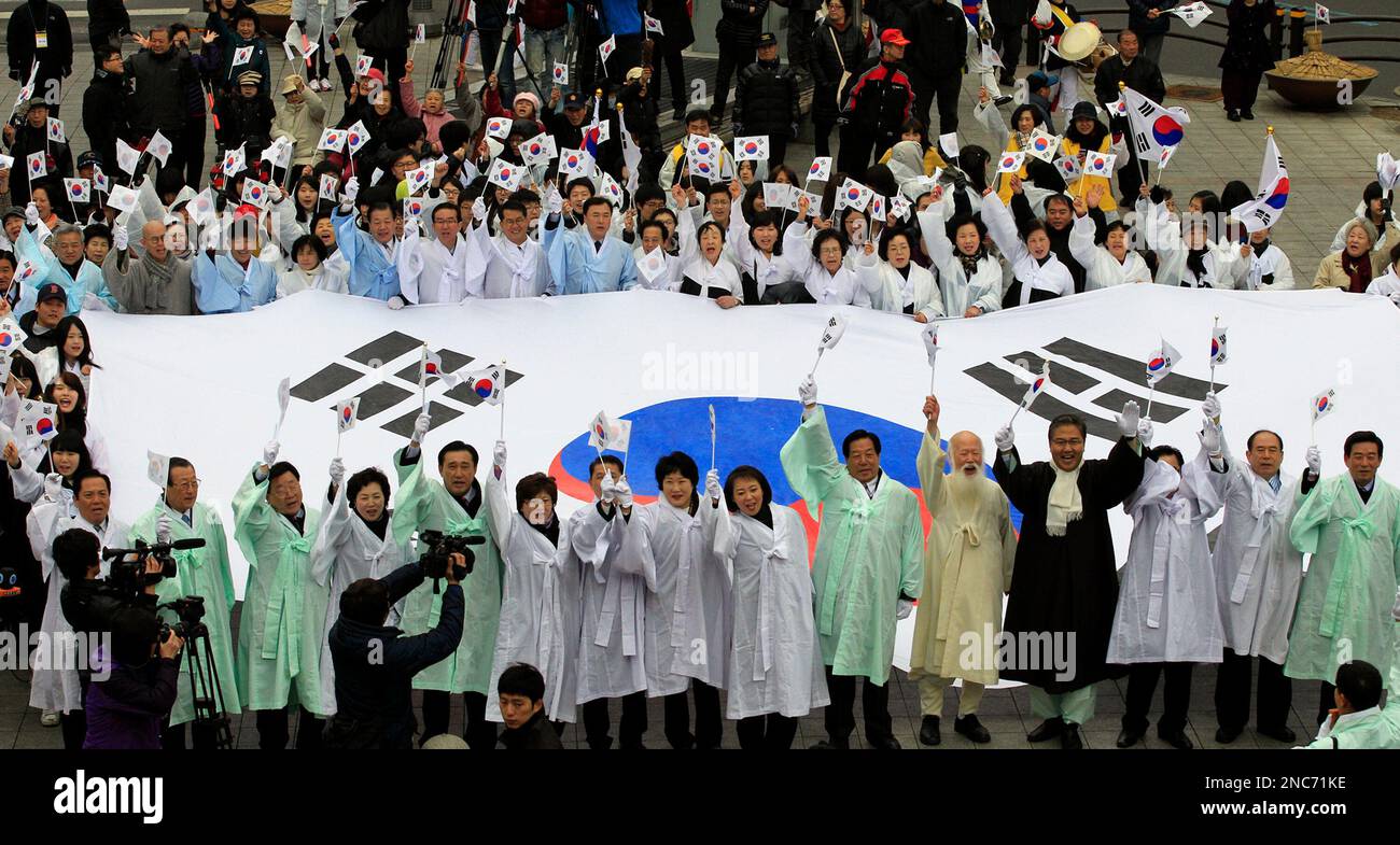 South Korean wearing traditional Korean costumes wave the national ...