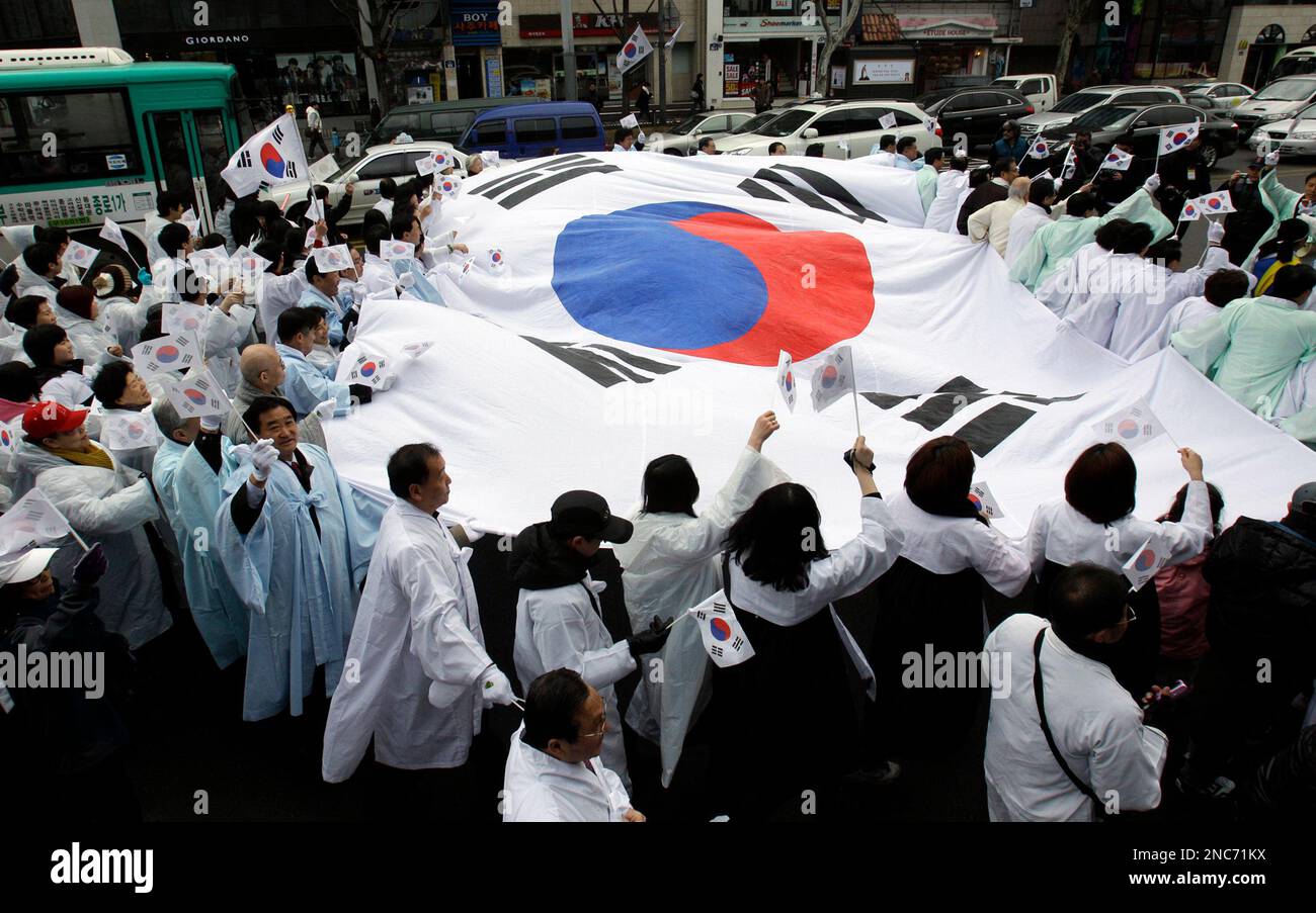 South Korean wearing traditional Korean costumes wave the national ...