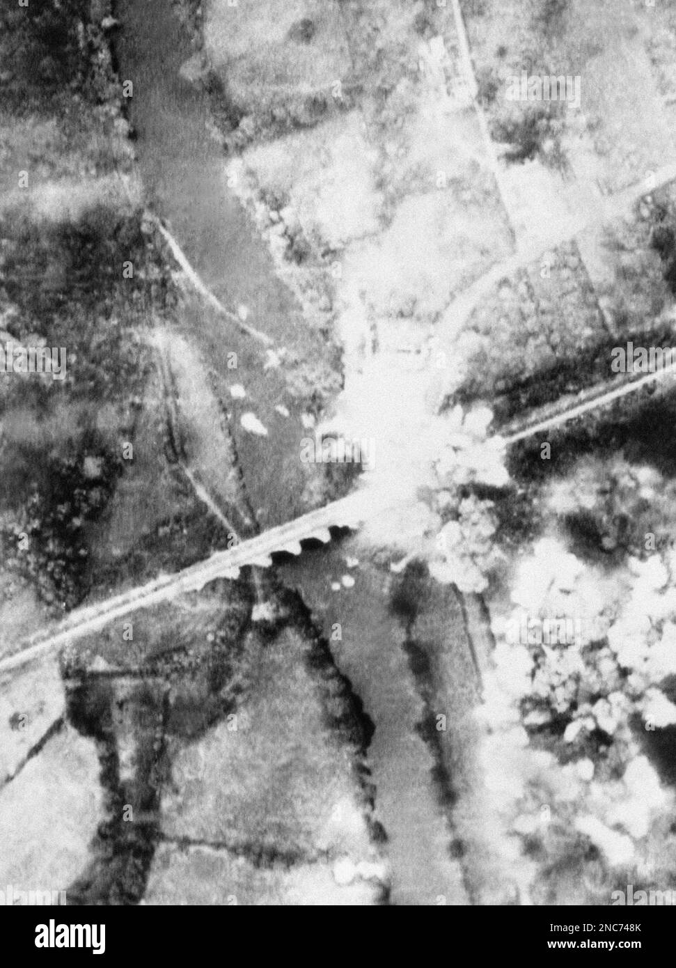 Bombs dropped by B-26 Marauder planes of the U.S. 9th Air Force pound ...