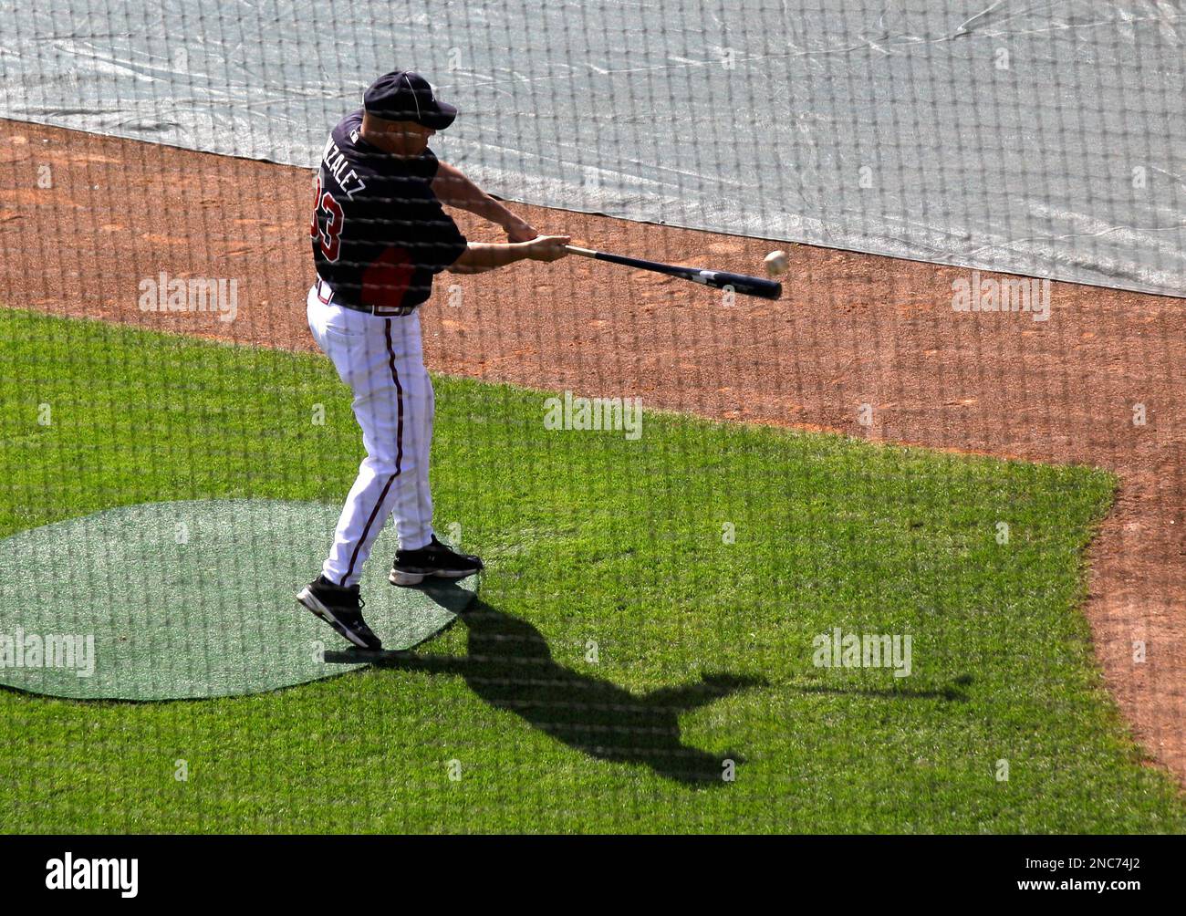 Atlanta Braves manager Fredi Gonzalez hits ground balls to infielders ...
