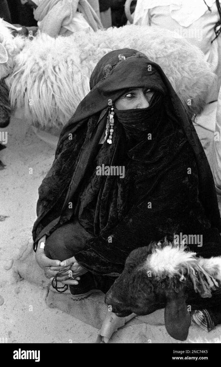 A Bedouin tribeswoman sits near two goats. Women of the nomadic Bedouin ...