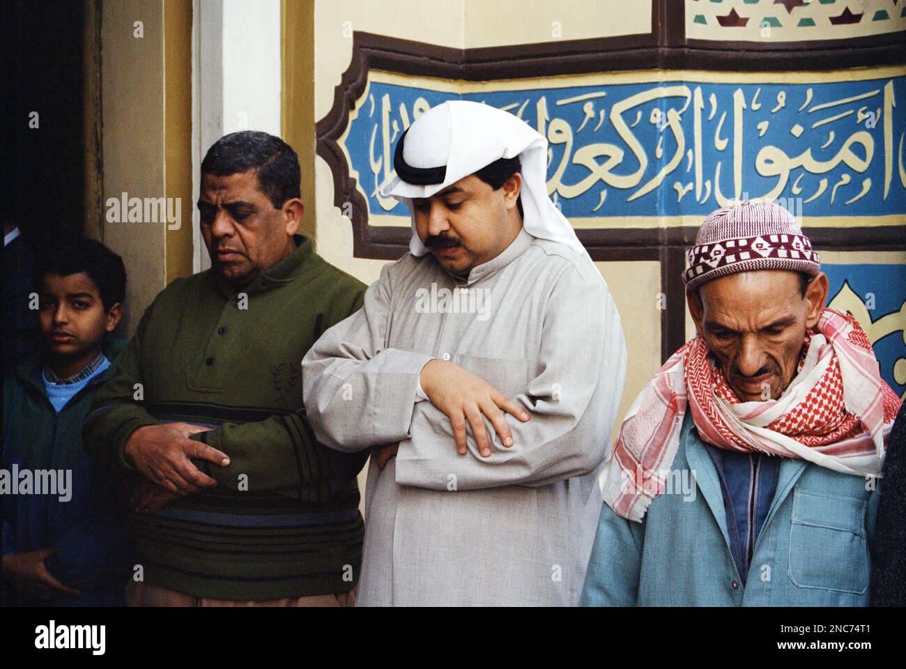 A Kuwaiti, left, and an Egyptian Muslim pray side by side for peace in ...