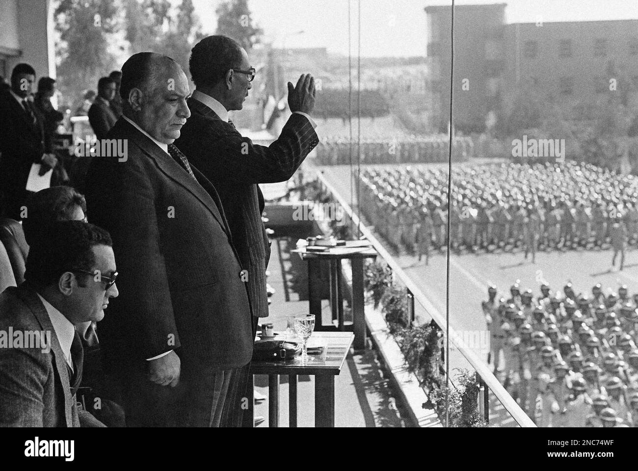 President Anwar Sadat of Egypt, takes the salute as the army marches ...