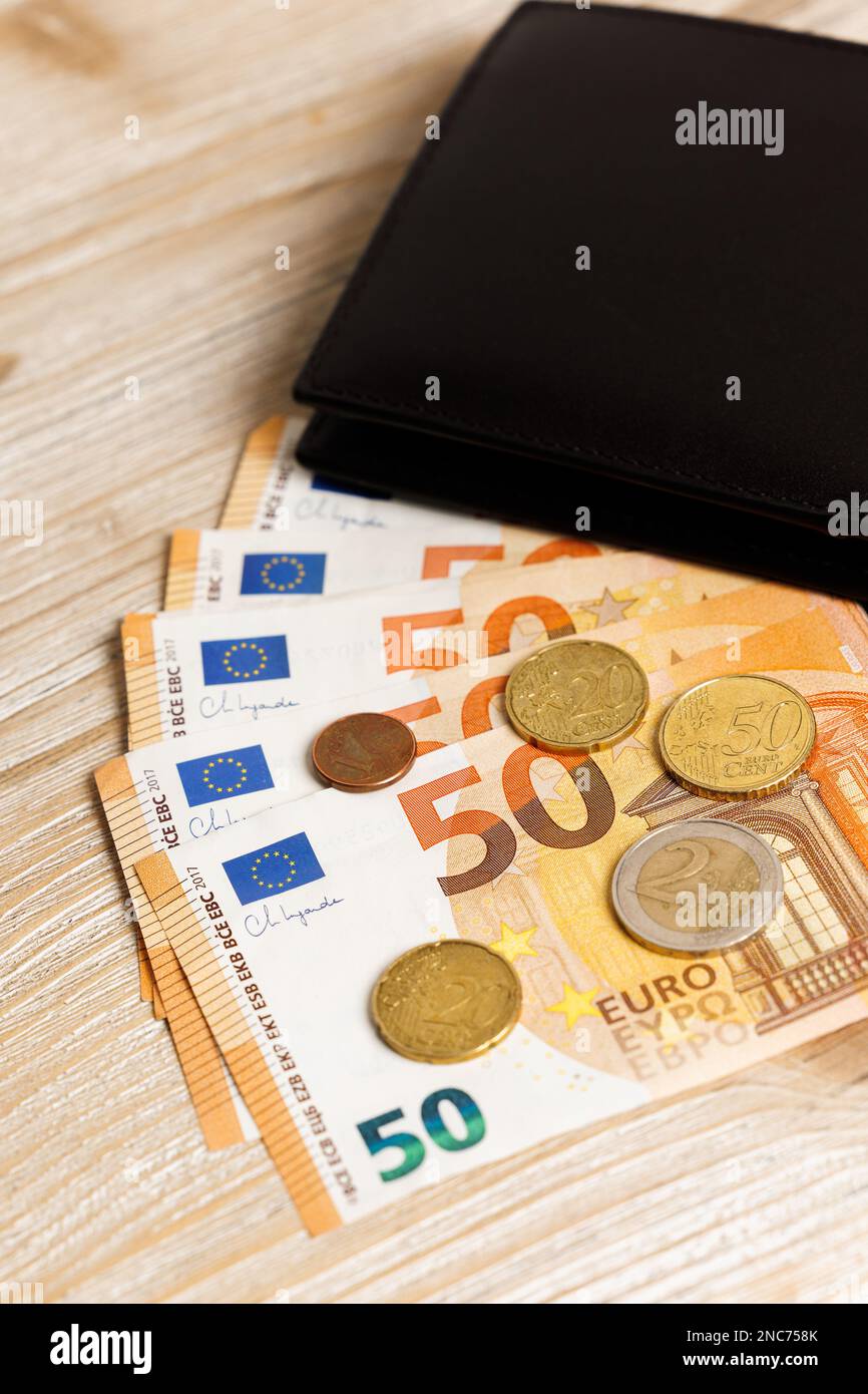 Euro bills and coins on a table Stock Photo - Alamy