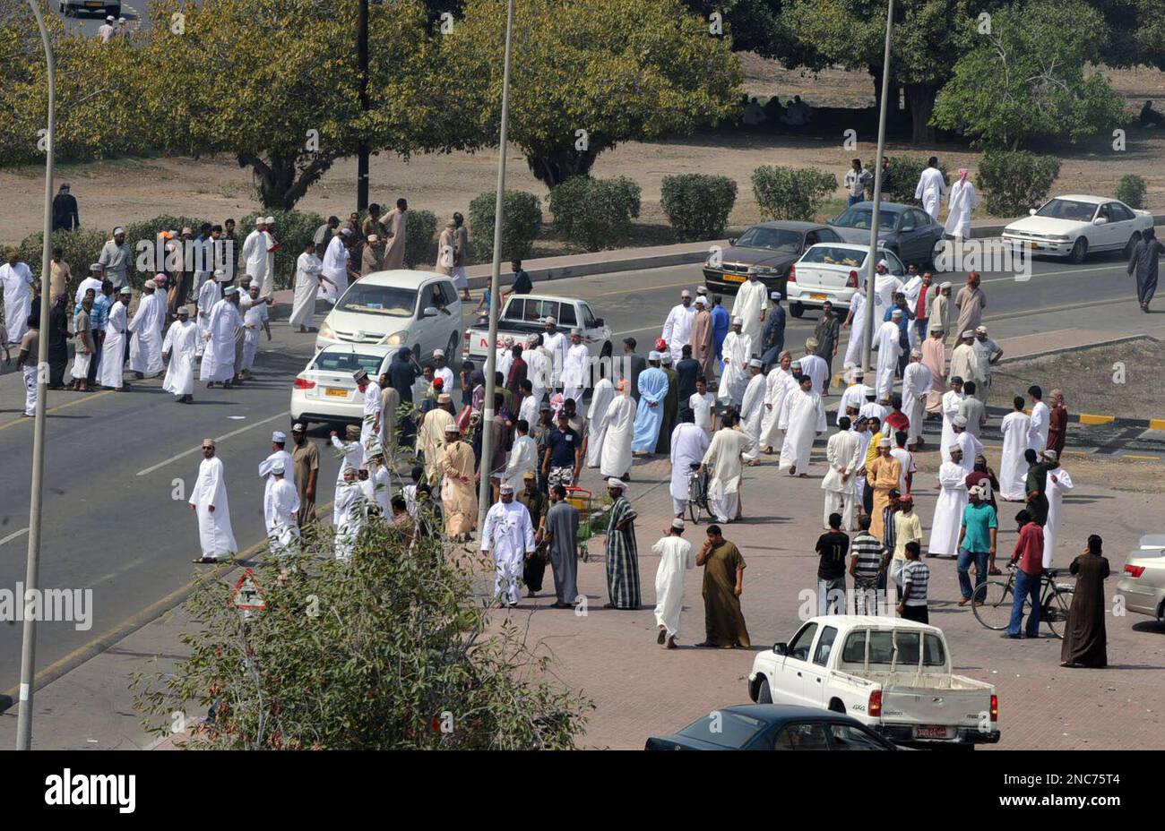 Omani people gather at the main Sohar roundabout in Sohar, Oman, Monday ...