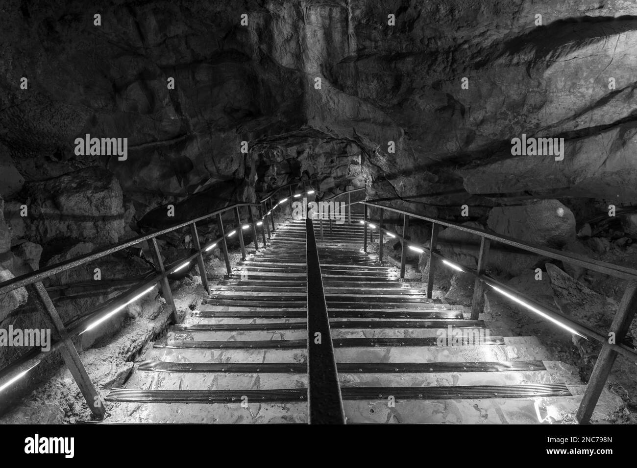 An illuminated staircase inside Goughs Cave in Cheddar in Somerset ...