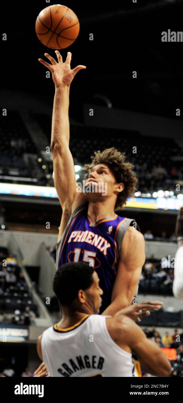 Phoenix Suns center Robin Lopez, top, shoots over Indiana Pacer forward ...