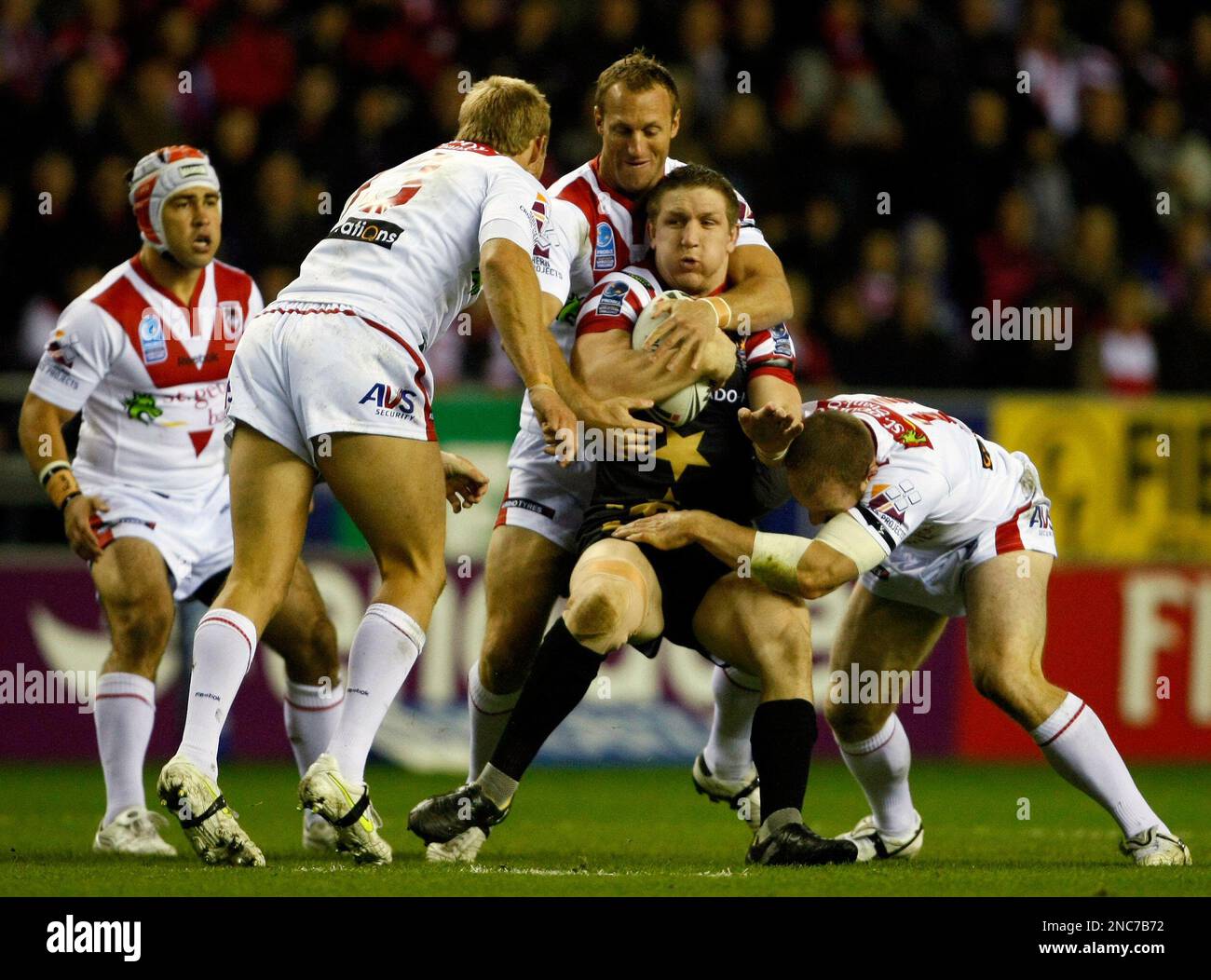 Wigan Warriors' Ryan Hoffman is tackled by St. George Illawarra Dragons ...