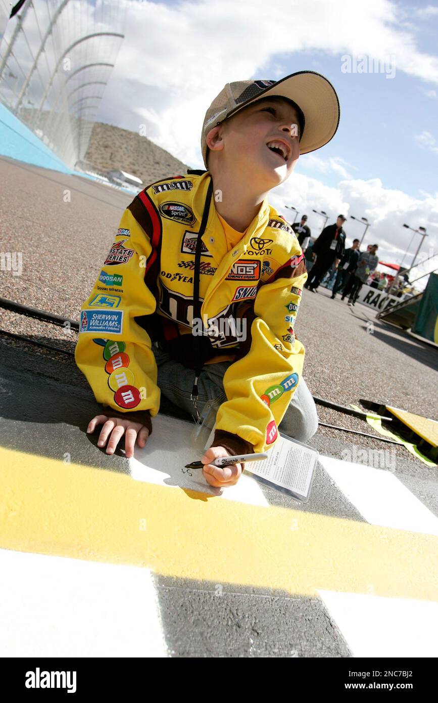 Racing fan Aiden Stevens, of San Diego, Calif., signs his name on the ...