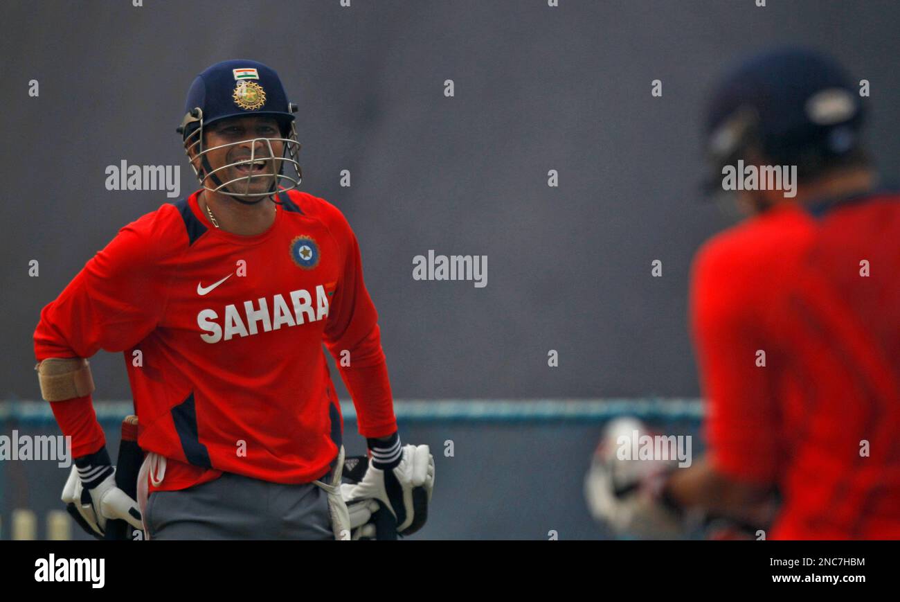 Indian cricketer Sachin Tendulkar talks to Suresh Raina during a ...