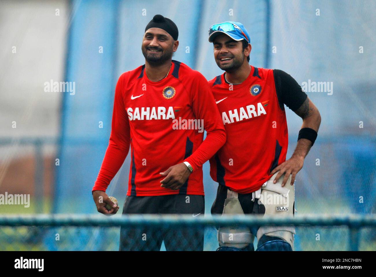 Indian cricketers Harbhajan Singh, left, and Virat Kohli share a light ...