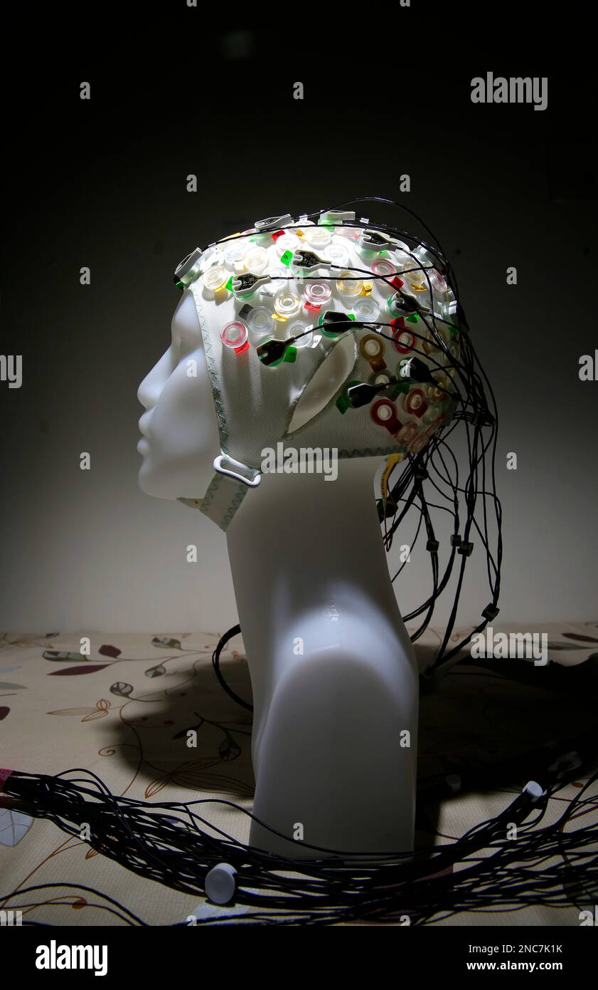 A EEG, (electrocephalgram) cap which is covered with sensors that ...