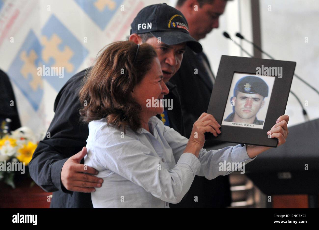 Maria Corral holds a photo of her late brother Pedro Corral during a ...