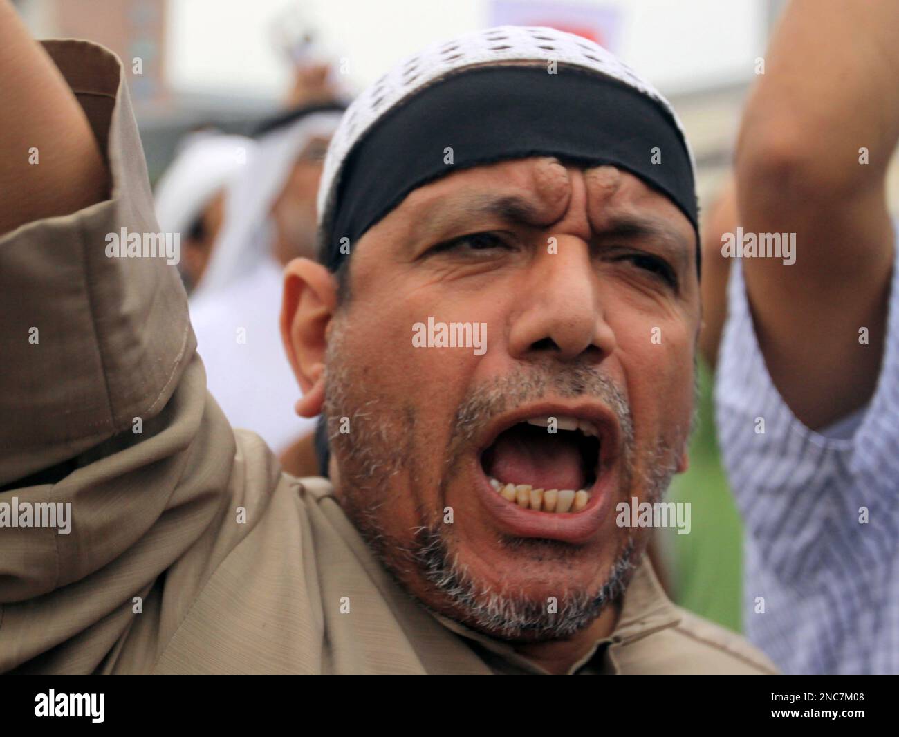 An unidentified Bahraini man chants during an anti-government protest ...