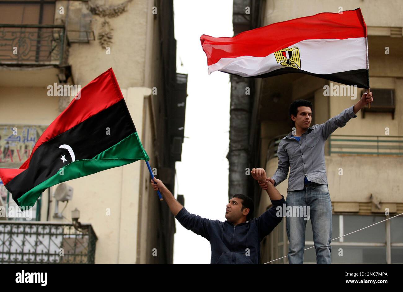 Egyptian protesters a wave Libya's old national flag and an Egyptian ...