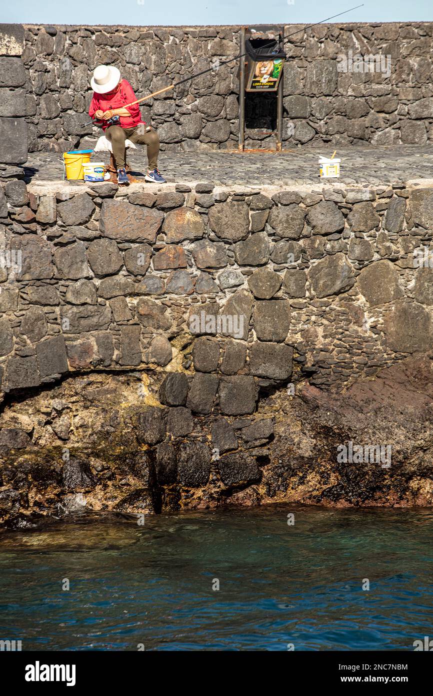 Locals Relaxation fishing off the picturesque seawall at Puerto de la ...