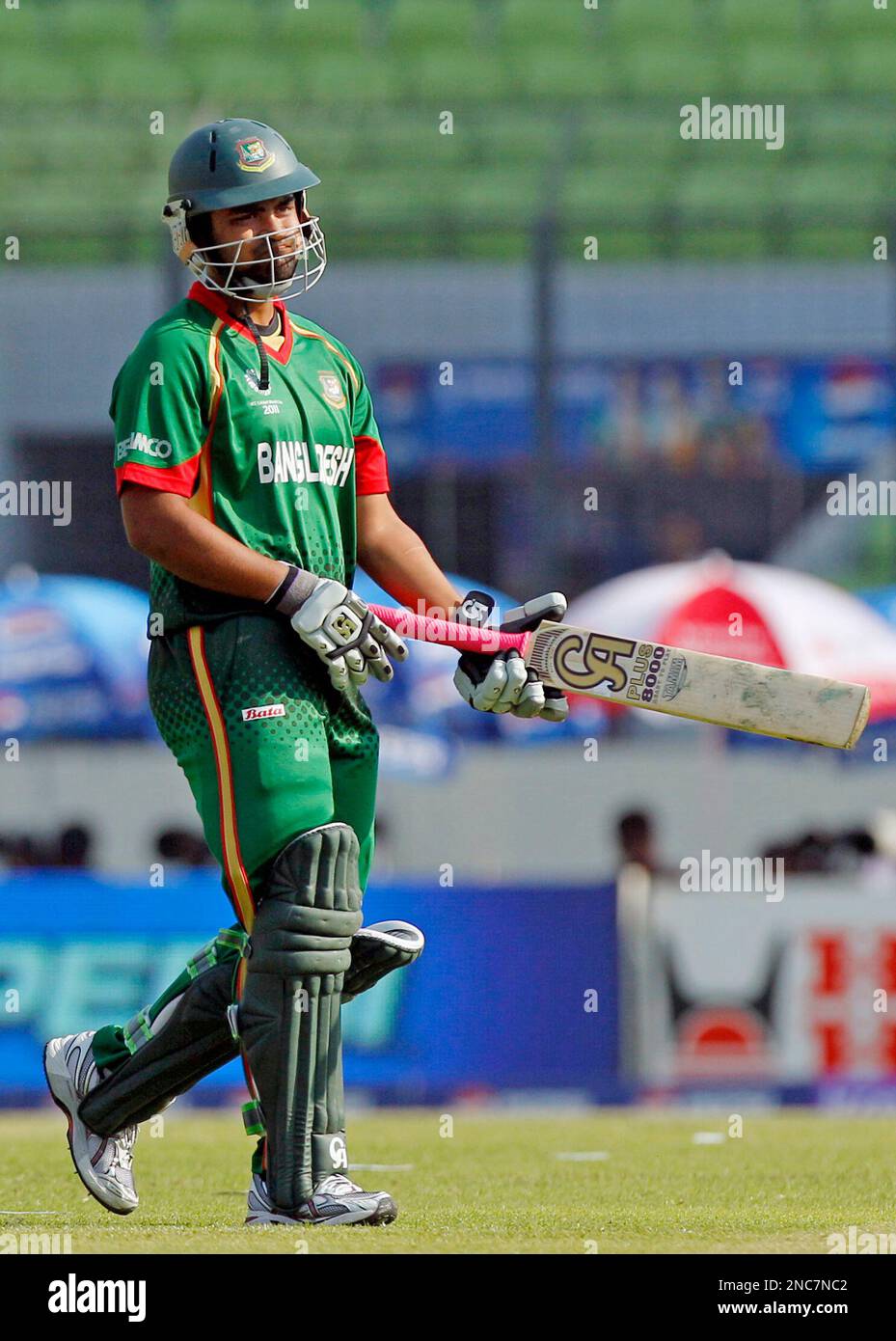 Bangladesh's batsman Tamim Iqbal leaves the field after being caught by ...
