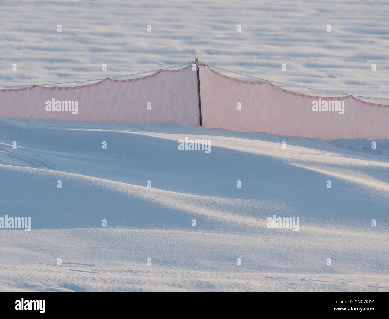 Snowy road trip: following the snow fences. Snow barriers lining the ...