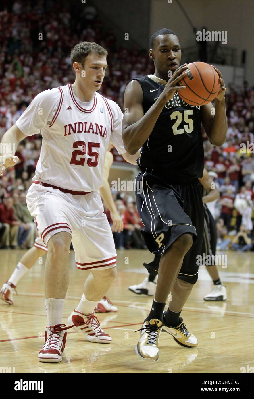 Purdue center JaJuan Johnson (25) goes against Indiana forward Tom ...