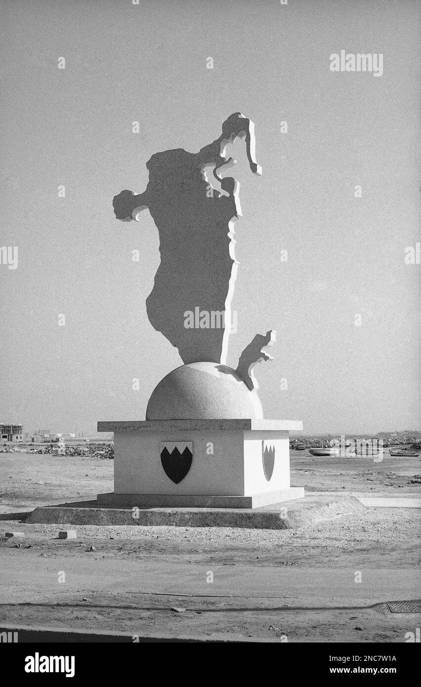 A stone in the shape of the map of Bahrain, resting on a ball-shaped ...