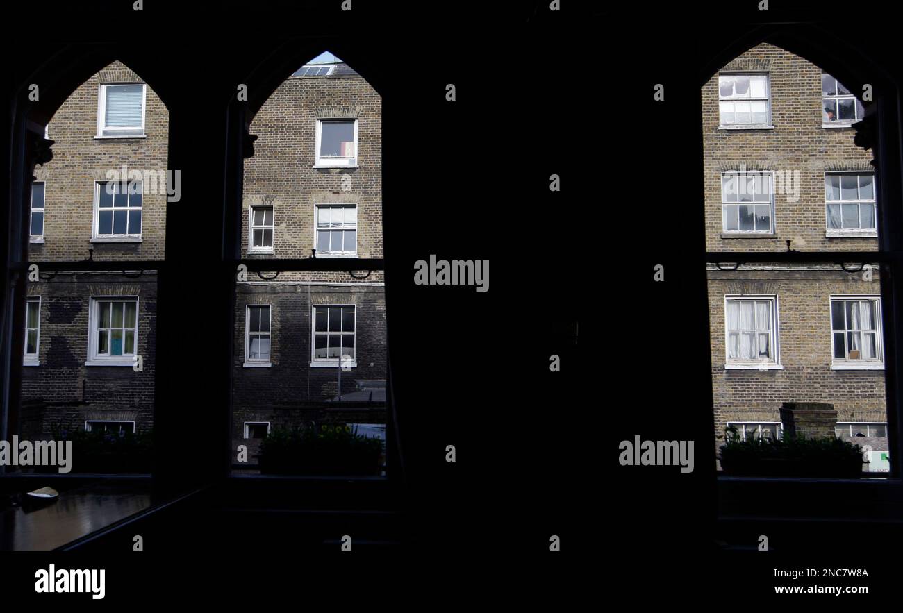 A dilapidated brick building in central London is seen through pub's ...