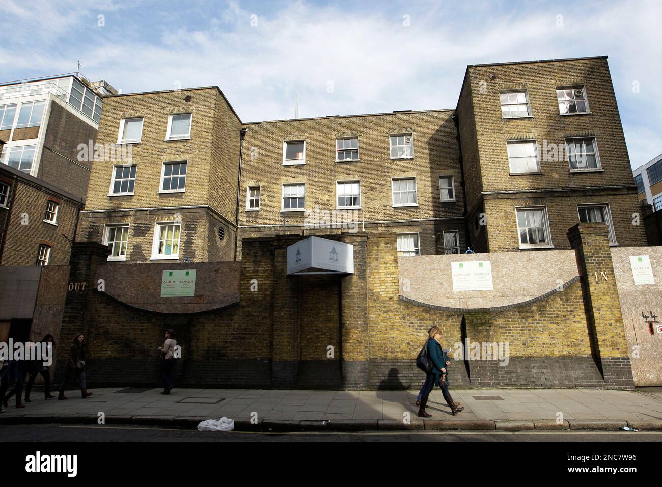 People walk by a dilapidated brick building in central London, where ...