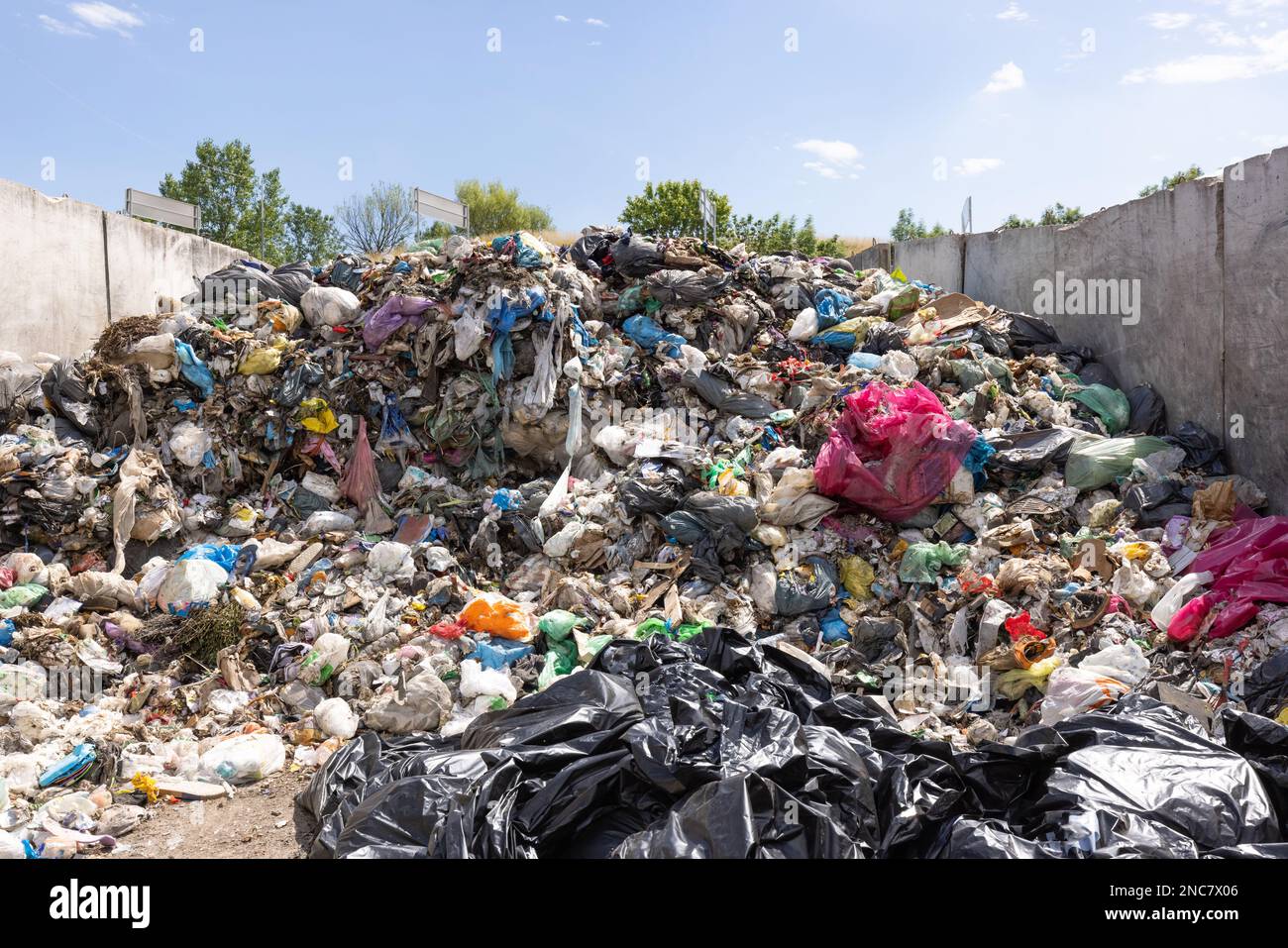 Landfill site, a pile of stinky different junk disposal in the concrete ...