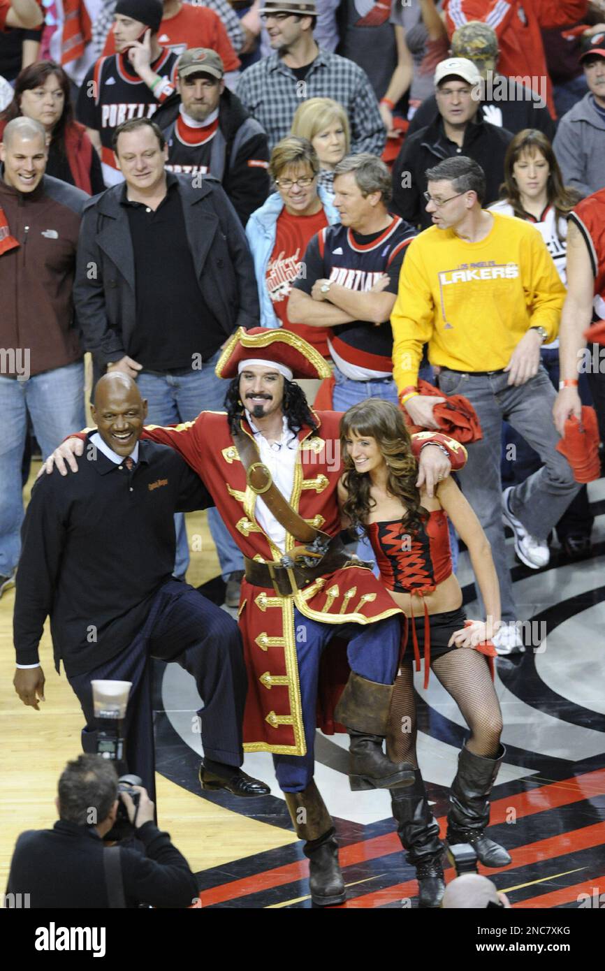 Captain Morgan, center, and Trail Blazers' legend Terry Porter, break ...