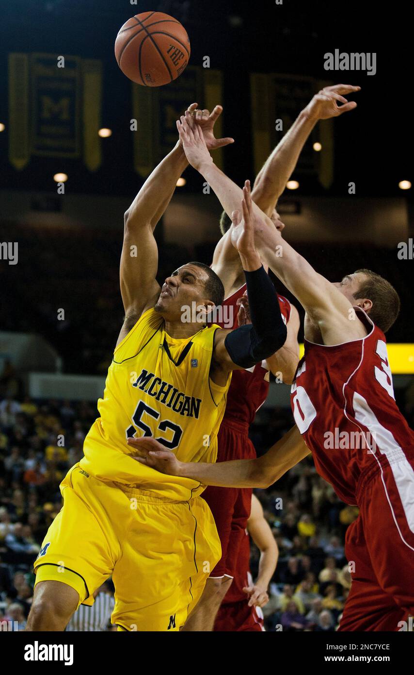 Michigan forward Jordan Morgan (52) has his shot broken up by Wisconsin ...