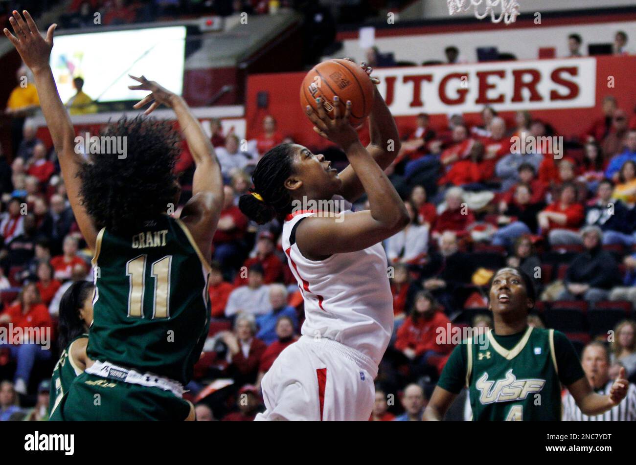 Rutgers' Monique Oliver takes a shot past South Florida's Porche Grant ...