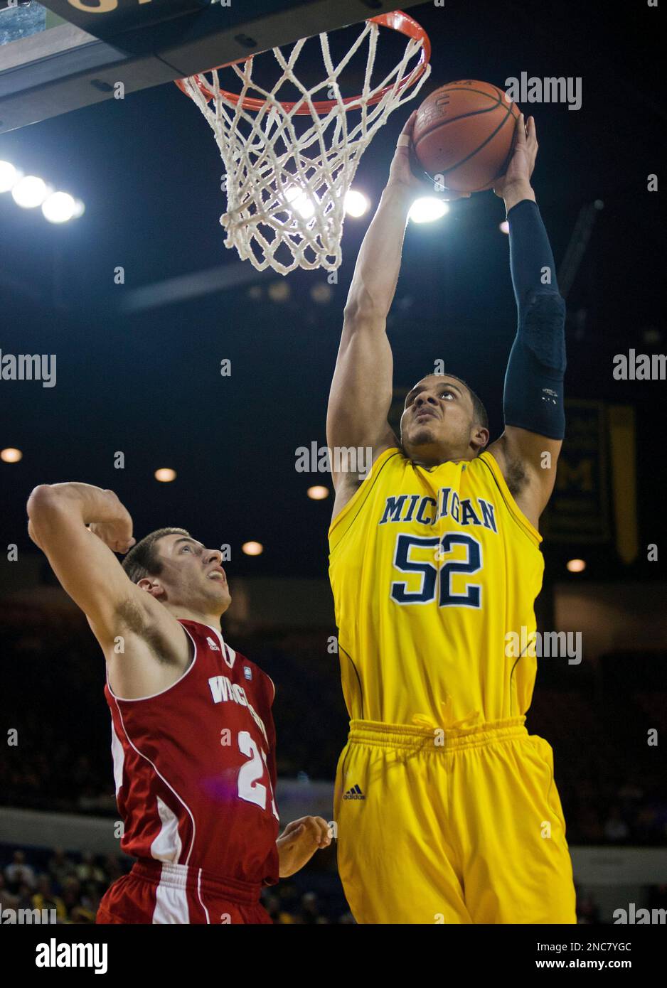 Wisconsin guard Josh Gasser, left, defends a dunk from Michigan forward ...