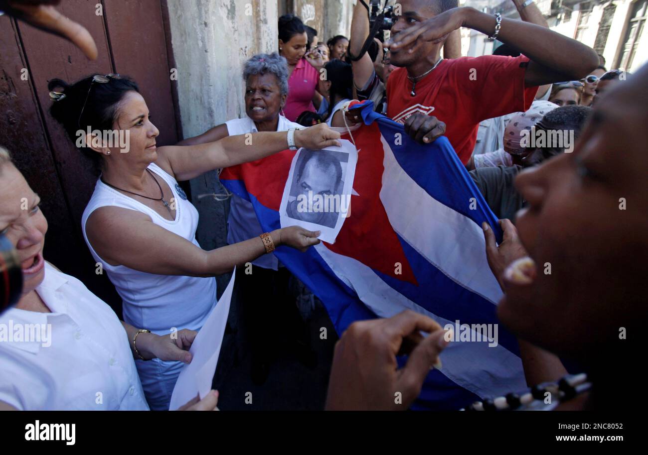 A member of the Cuban dissident group 'Ladies in White' holds an image ...