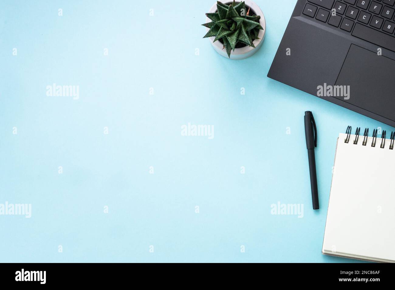 Office table desk with laptop, notepad and pen Stock Photo - Alamy