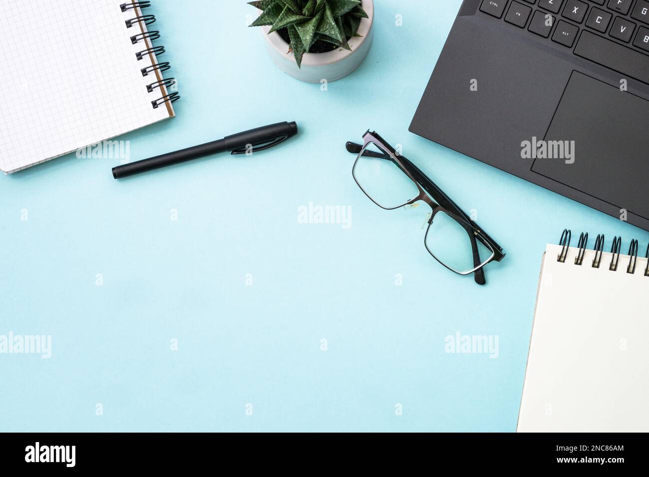 Office table desk with laptop, notepad and pen Stock Photo - Alamy