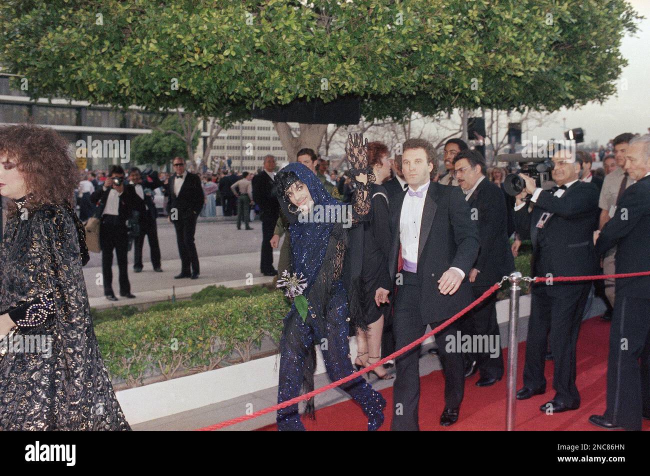 Rock singer Prince waves to the crowd upon his arrival outside the ...