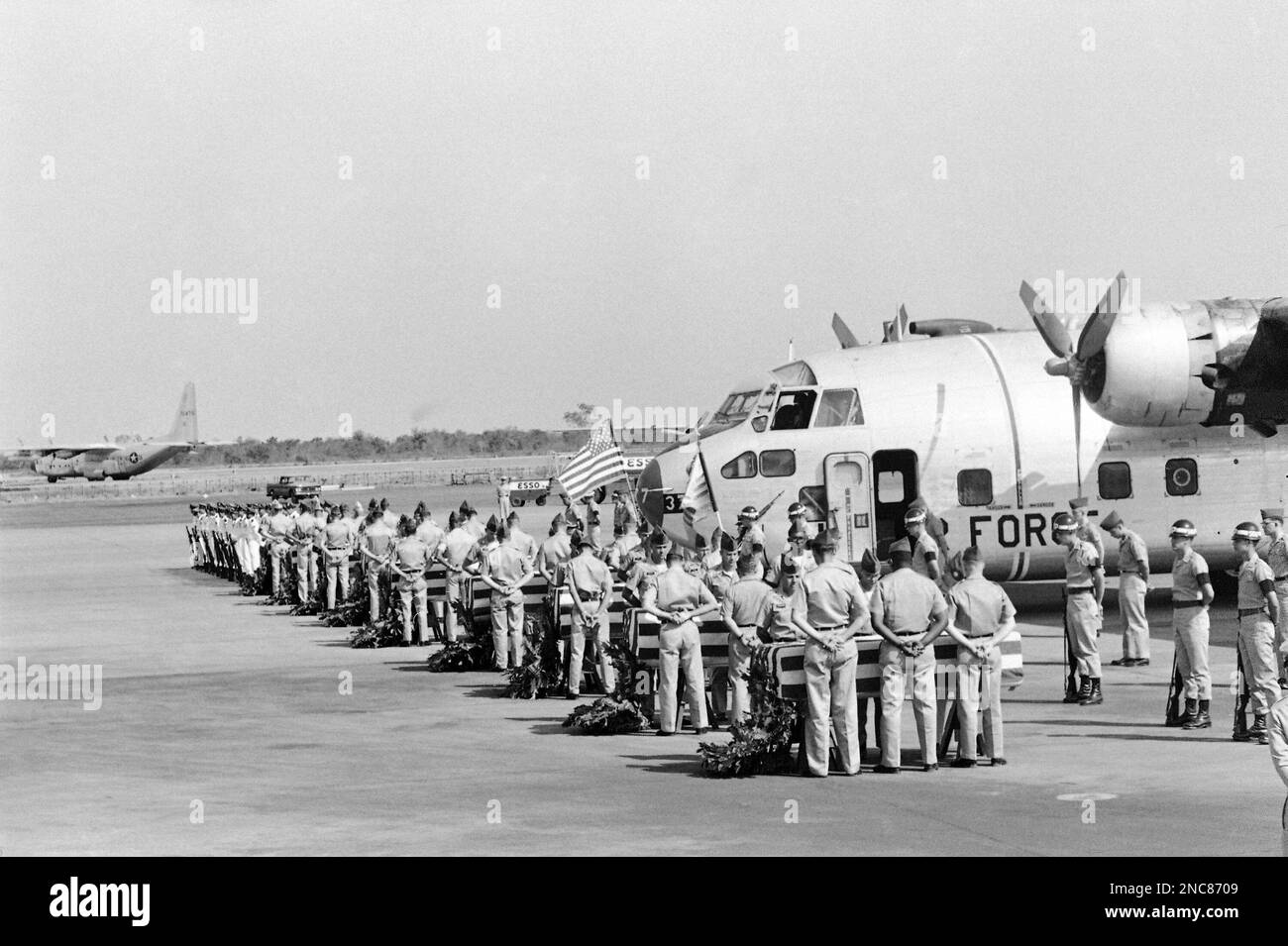 The flag draped coffins with bodies of the 8 victims of the Vietcong ...