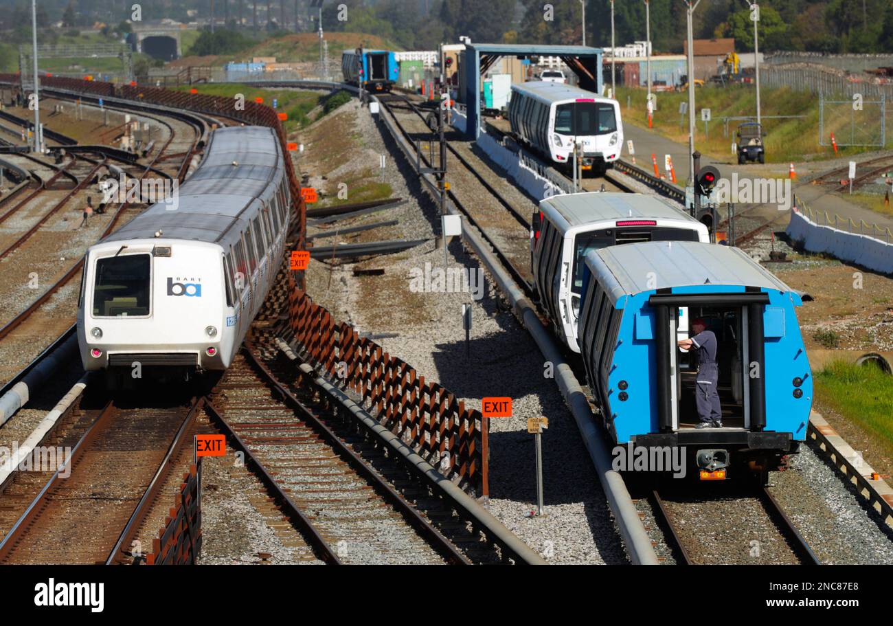 Workers begin testing of the new BART cars, (right) along the test ...