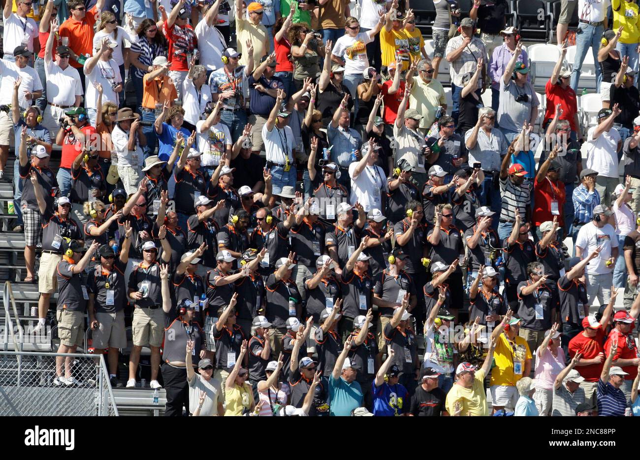 NASCAR fans hold up their arms with the number three to honor driver ...