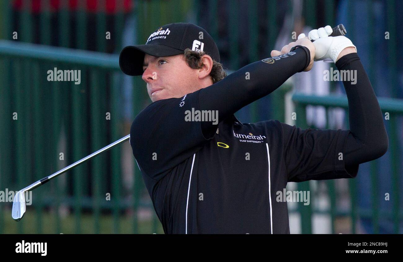 Rory McIlroy follows through on a swing while hitting the driving range ...